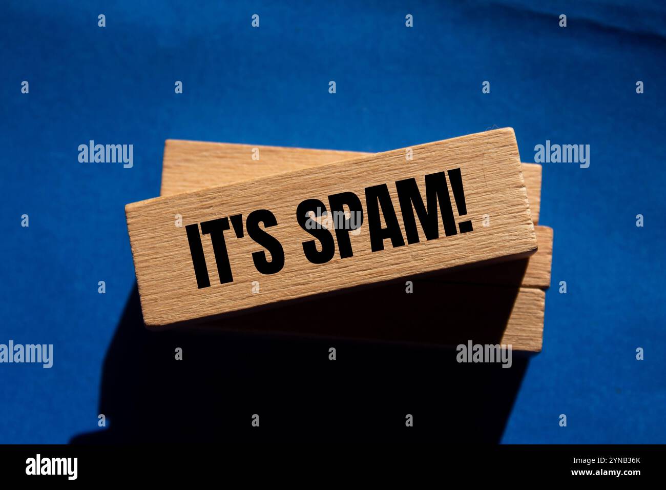It's spam message written on wooden blocks with blue background ...