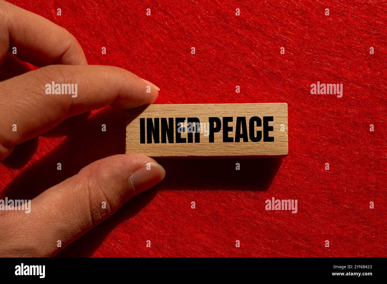 Inner peace message written on wooden block with red background ...