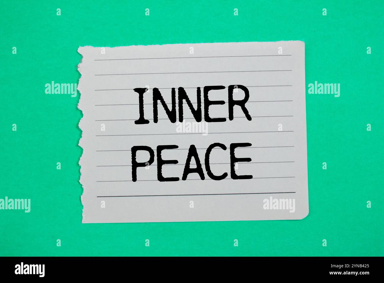 Inner peace message written on ripped torn paper piece with green ...