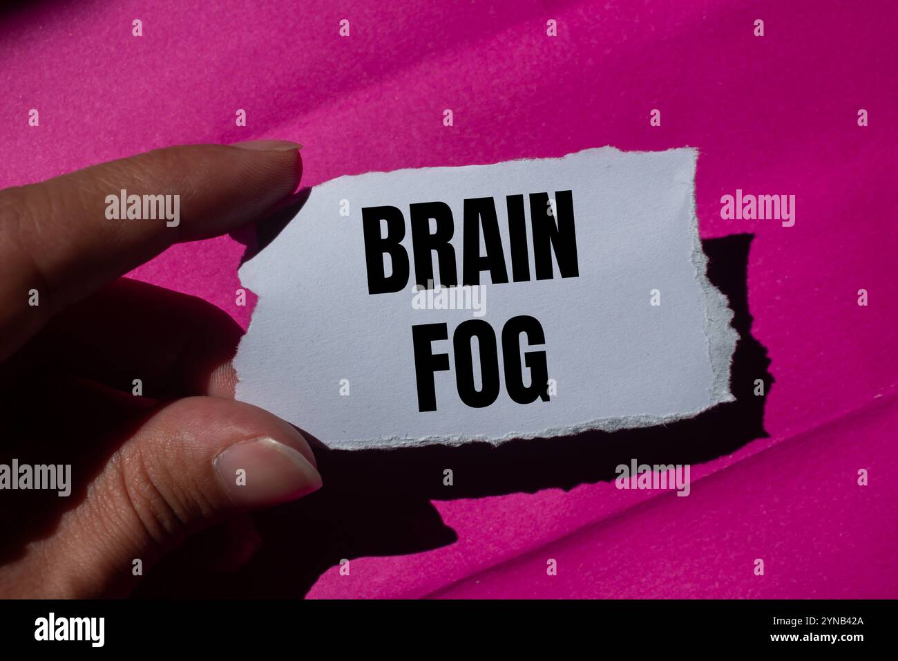 Brain fog message written on ripped torn paper piece with a pink ...