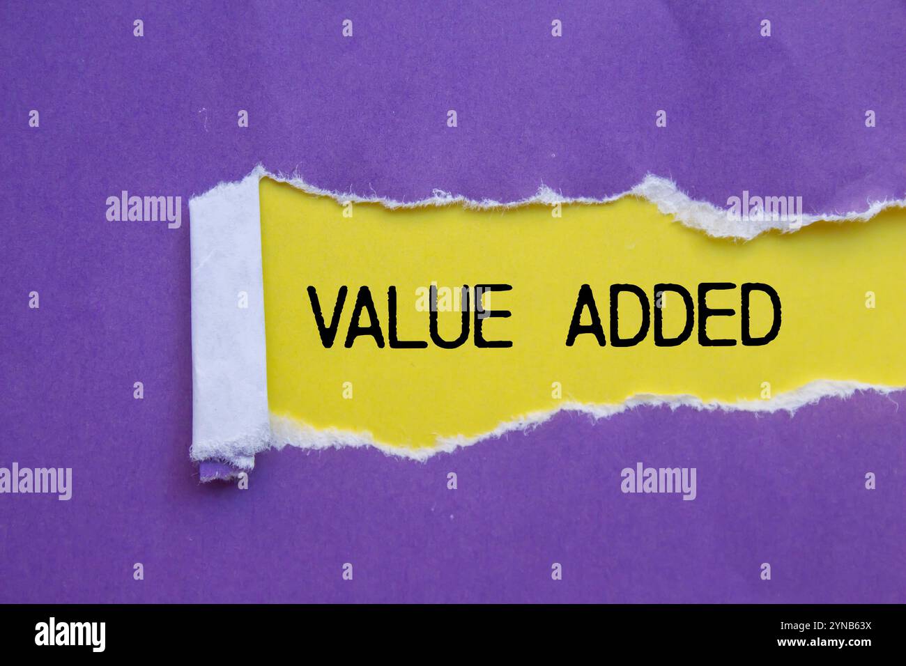 Value added message written on ripped torn purple paper with yellow ...
