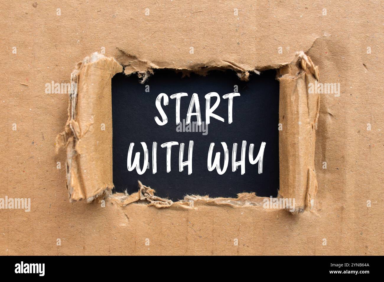 Start with why message written on ripped torn cardboard paper with black background. Conceptual ...