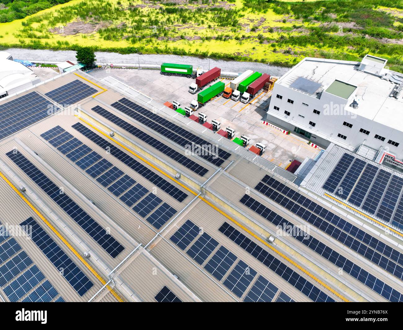 Solar-powered warehouse facility with freight trucks at loading docks ...