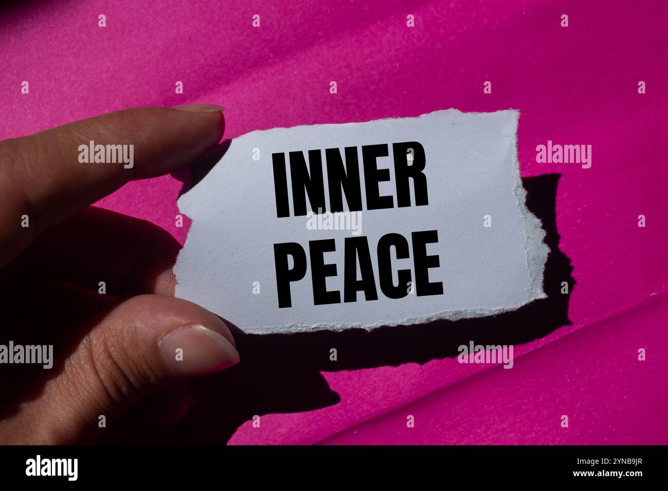 Inner peace message written on ripped torn paper piece with a pink ...