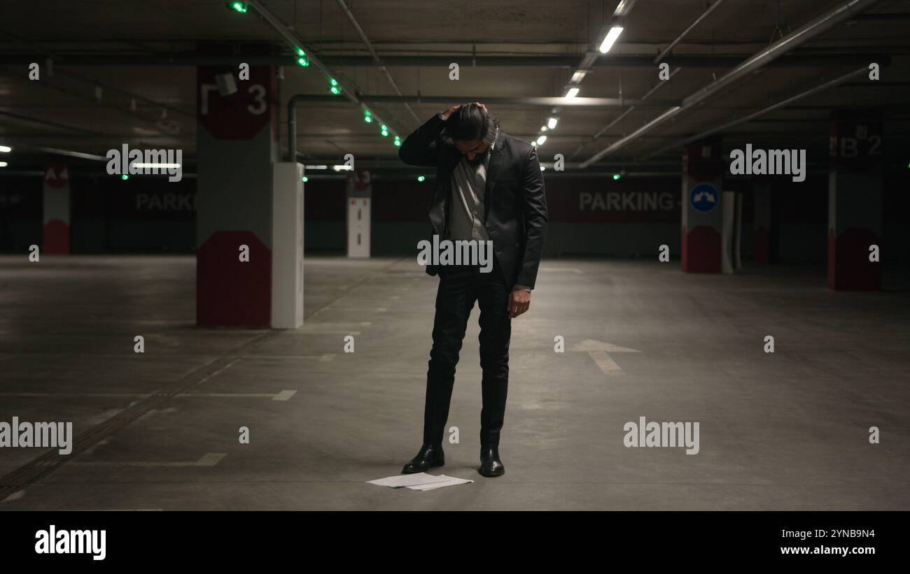 Stressed frustrated Indian man in underground parking lot suffering ...