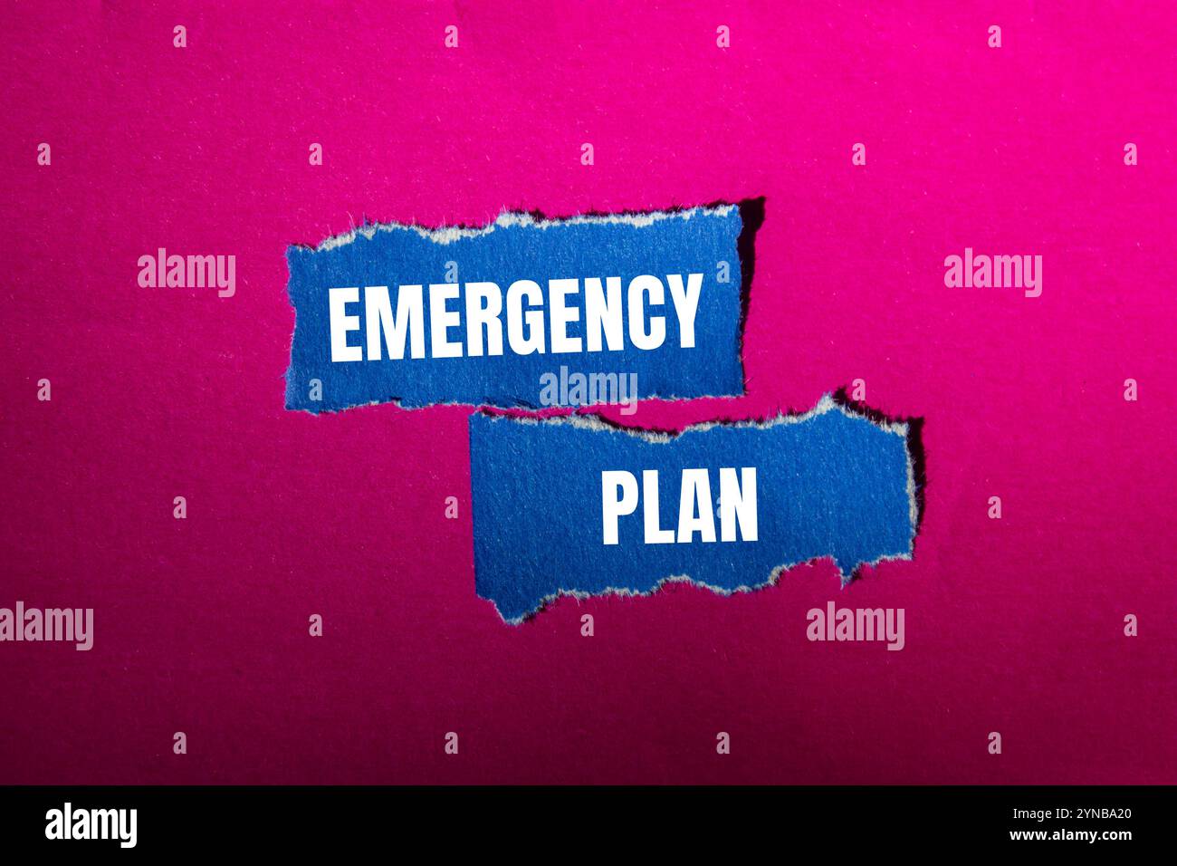 Emergency plan message written on ripped torn blue paper pieces with pink background. Conceptual ...