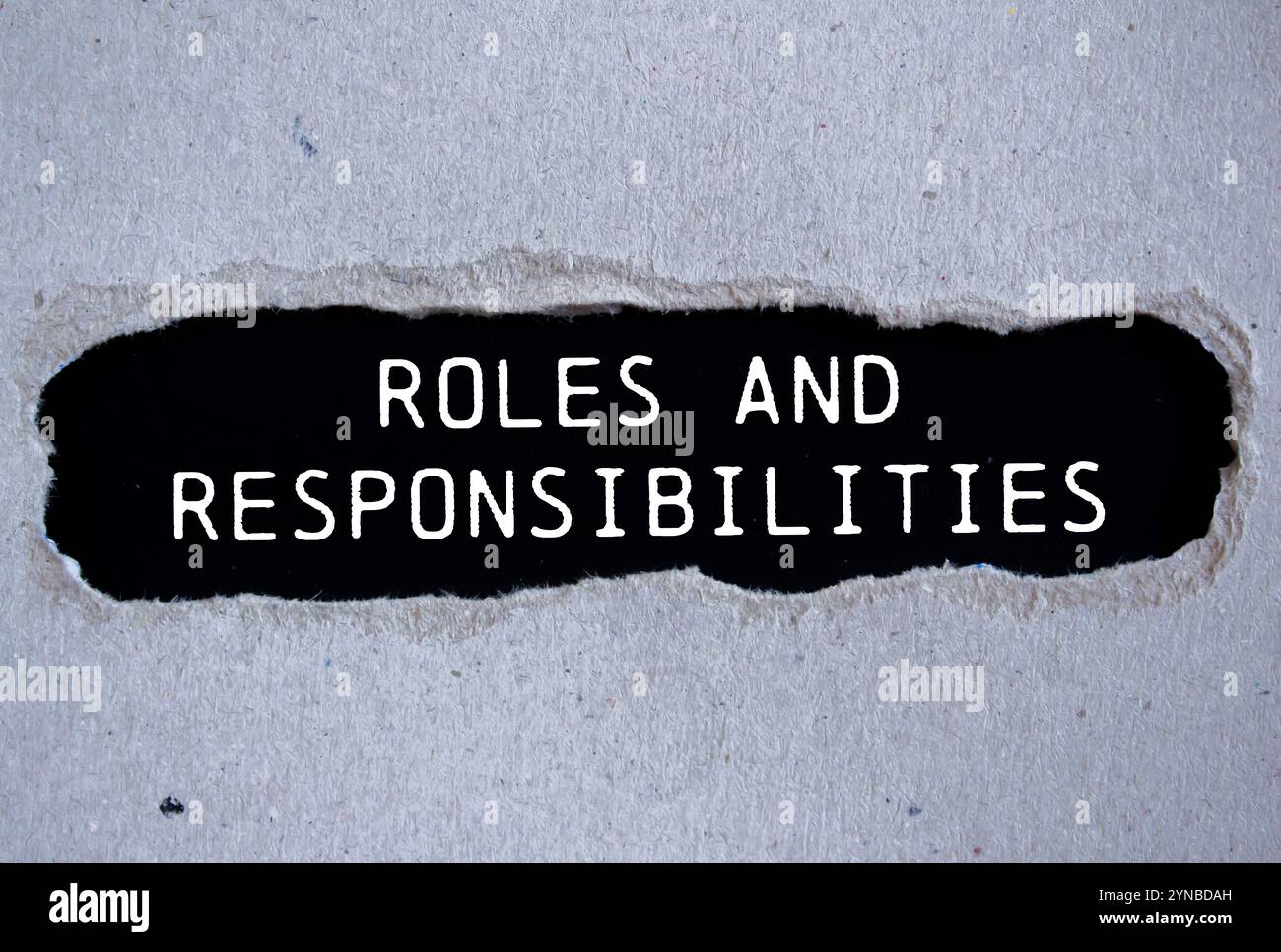 Roles and responsibilities message written on ripped torn gray paper ...