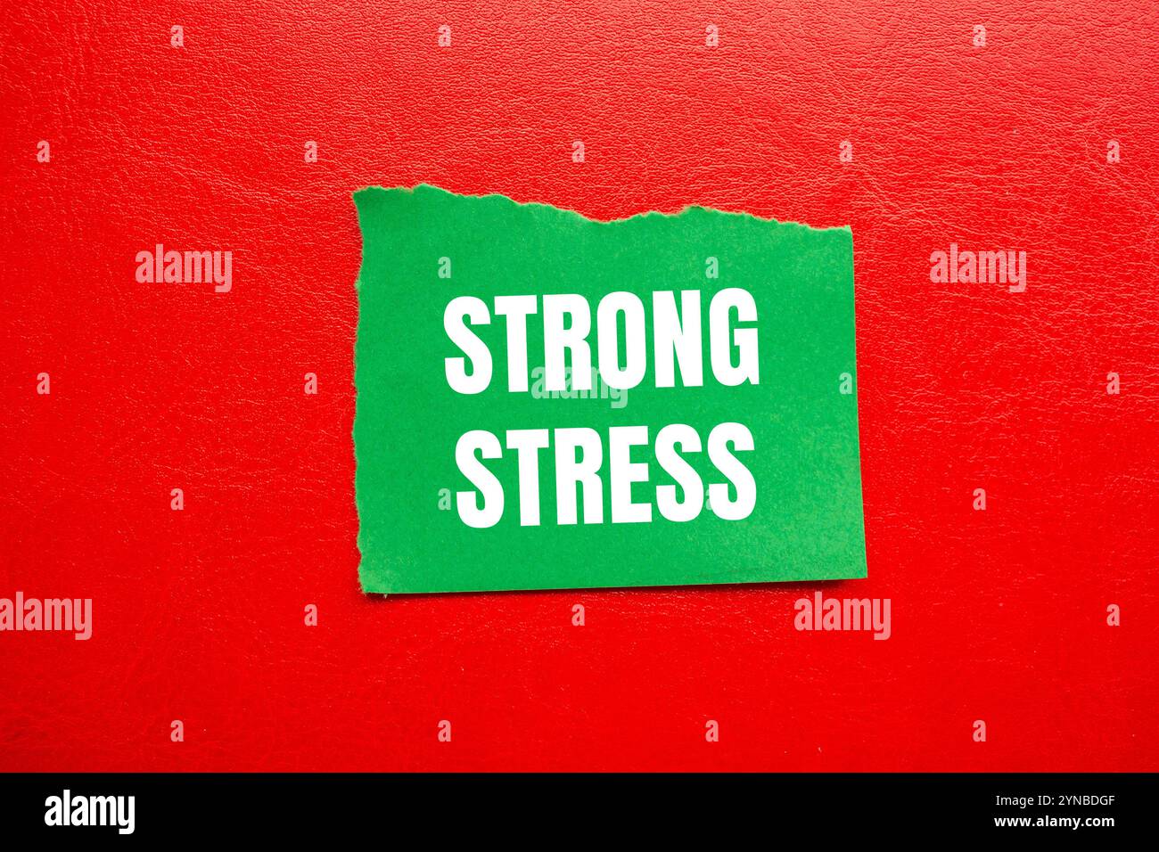 Strong stress message written on ripped torn green paper piece with red background. Conceptual ...