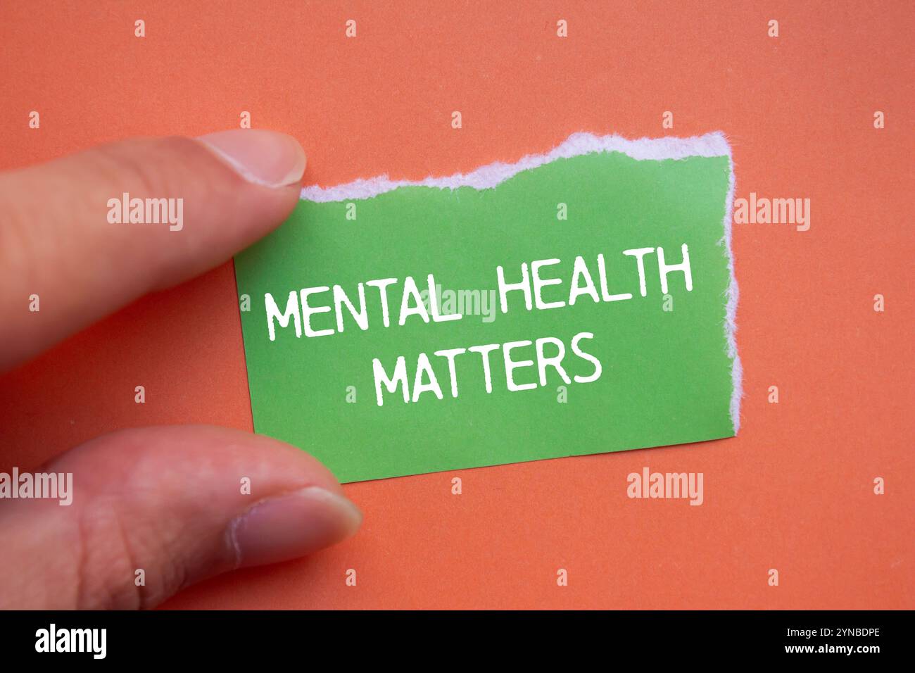 Mental health matters message written on ripped green torn paper with ...