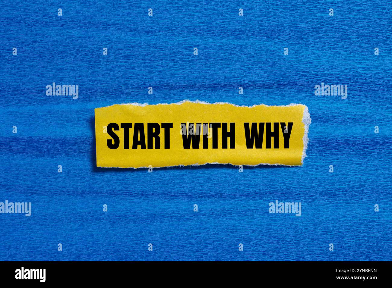 Start with why message written on ripped torn yellow paper piece with blue background ...