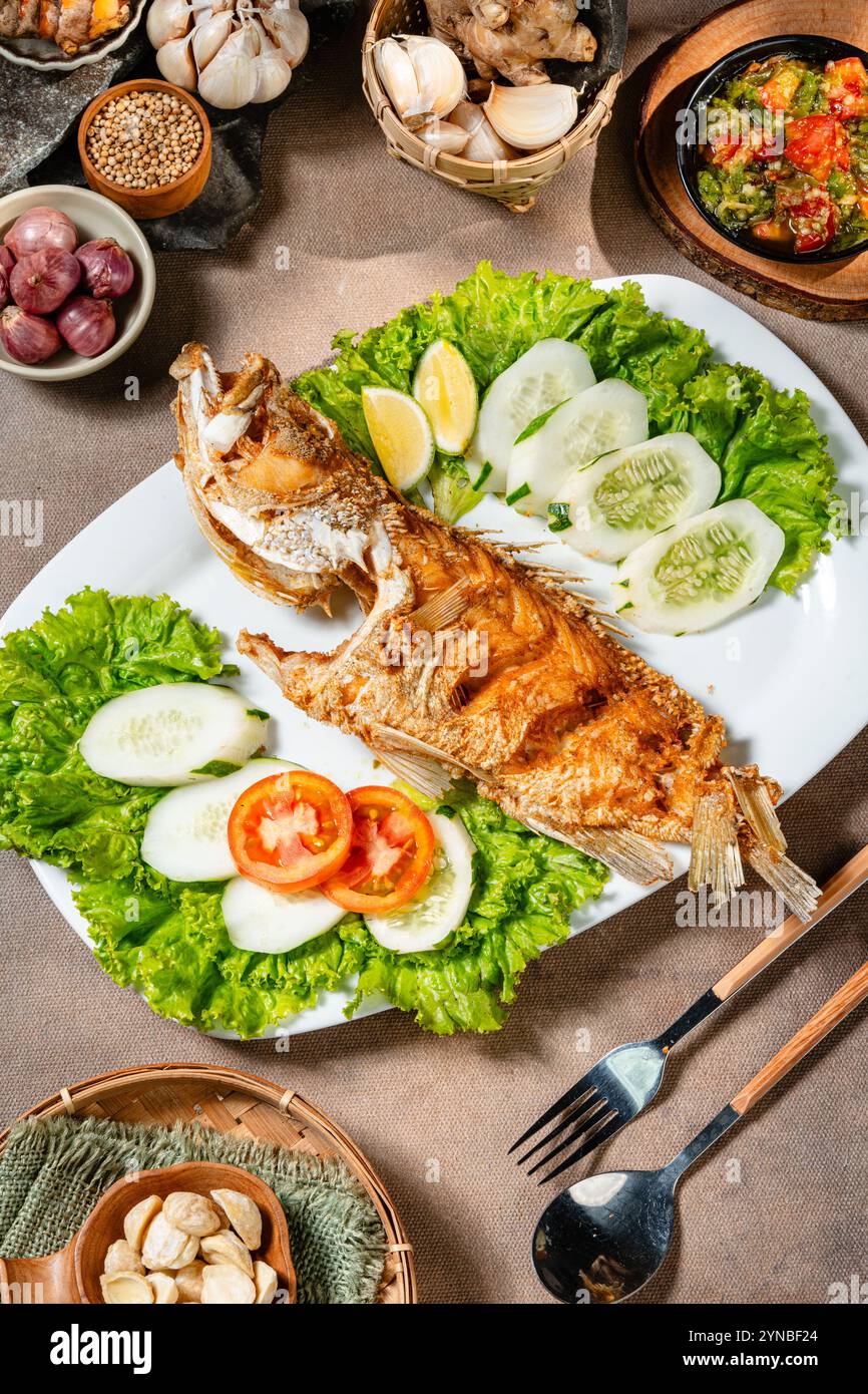 Deep fried crispy grouper fish with sambal dabu dabu Stock Photo - Alamy