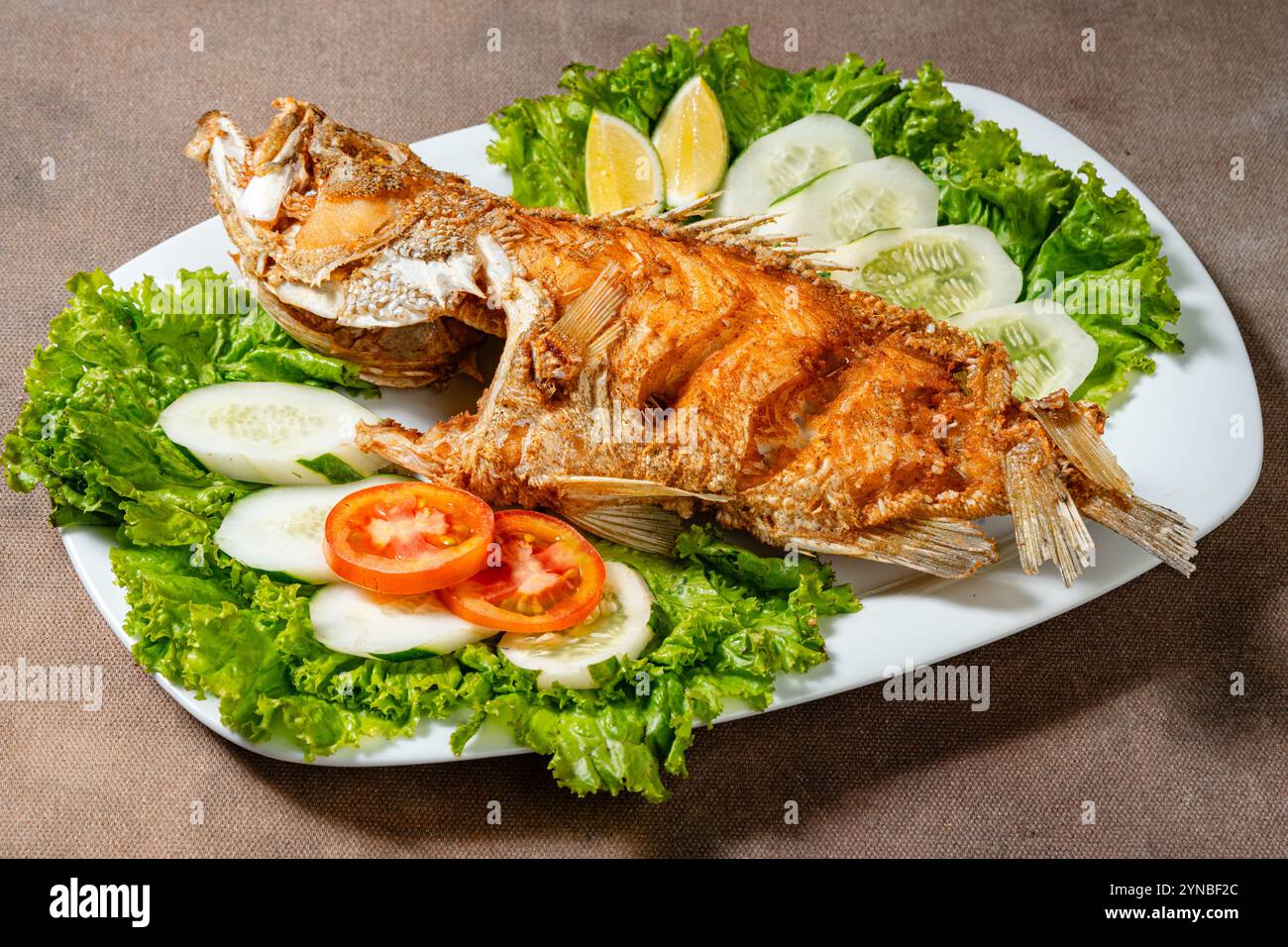Deep fried crispy grouper fish with sambal dabu dabu Stock Photo - Alamy