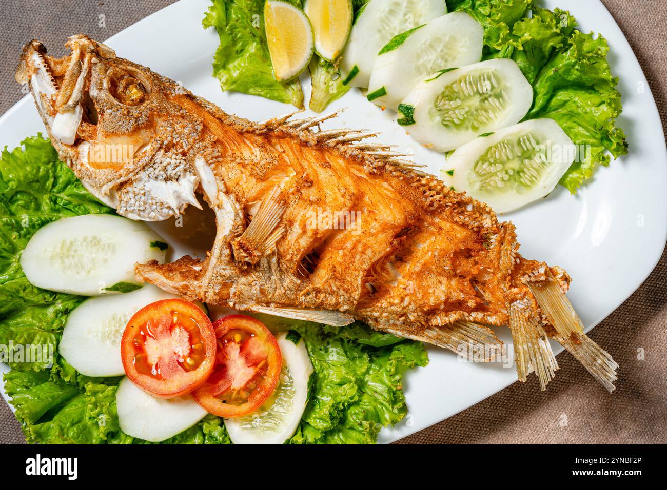 Deep fried crispy grouper fish with sambal dabu dabu Stock Photo - Alamy