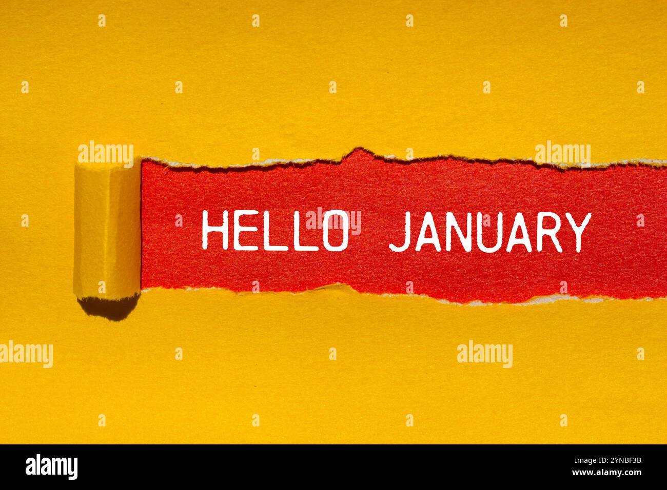 Hello january message written on ripped torn yellow paper with red ...