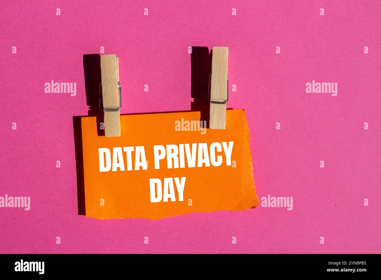 Data privacy day message written on ripped torn orange paper piece with ...