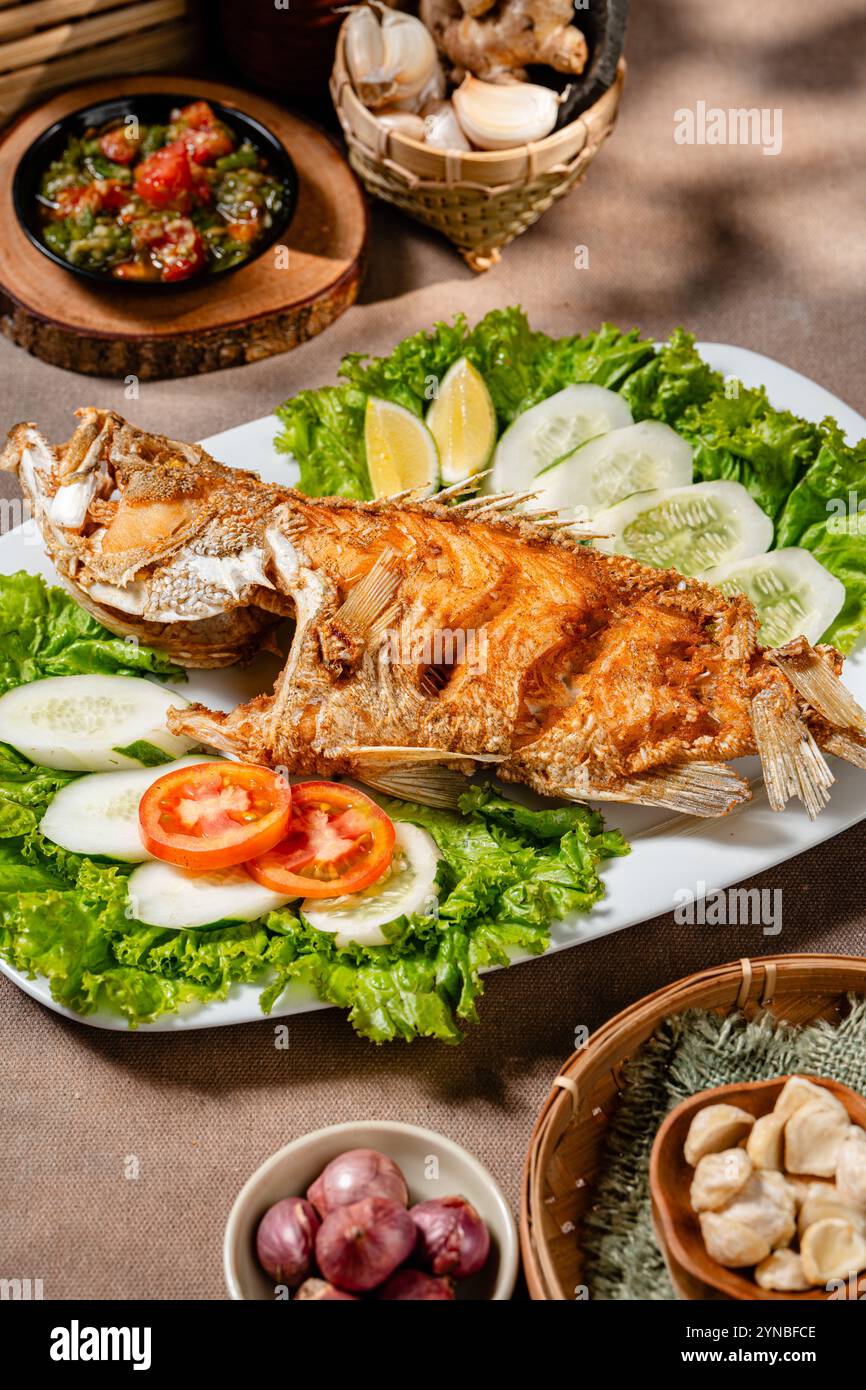 Deep fried crispy grouper fish with sambal dabu dabu Stock Photo - Alamy