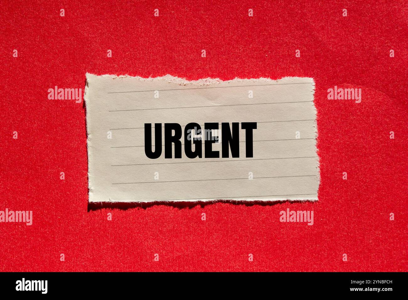 Urgent message written on ripped torn paper piece with red background ...