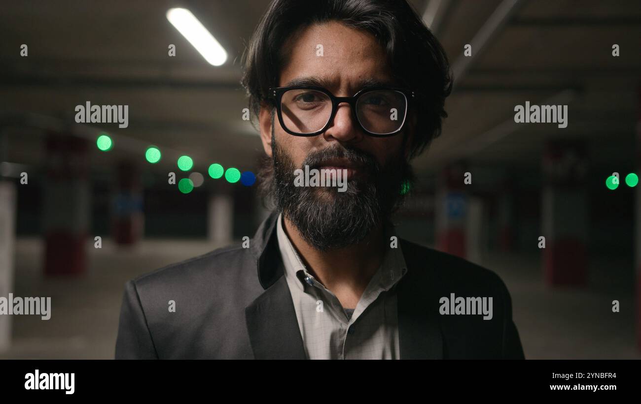 Stressed frustrated Indian man in underground parking lot suffering ...