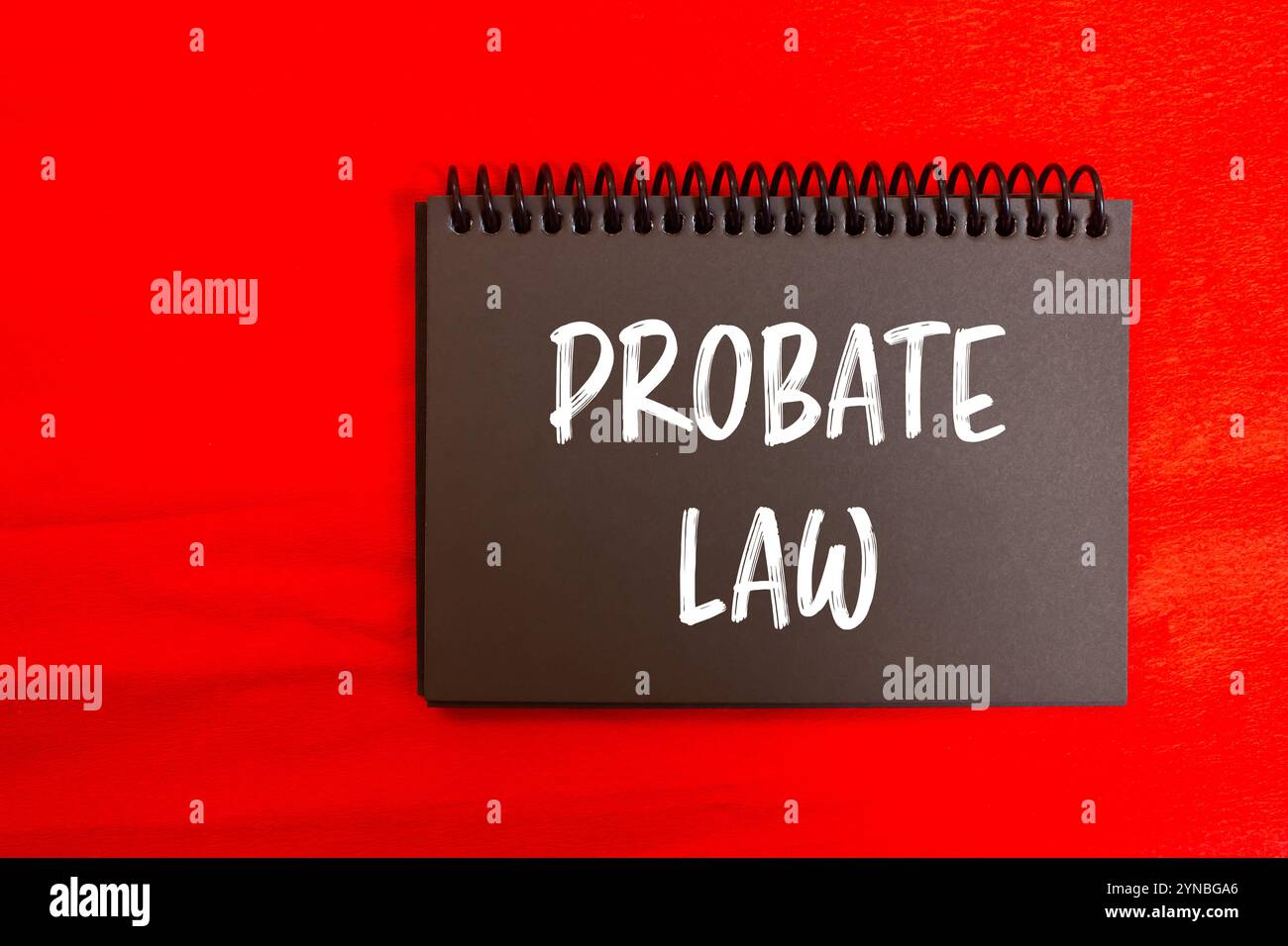 Probate law message written on black notebook page with red background ...