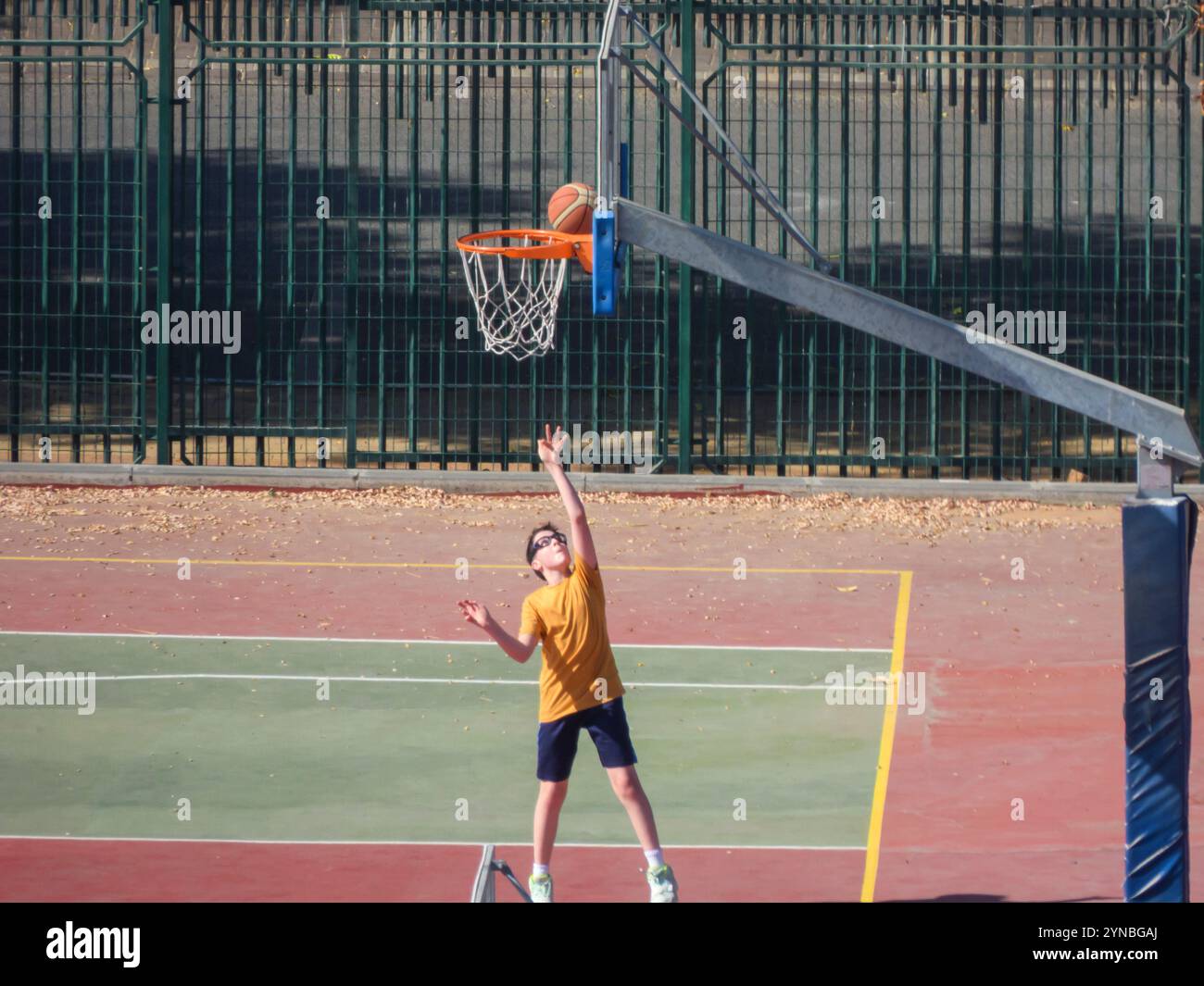 Boy shooting basketball hi-res stock photography and images - Alamy