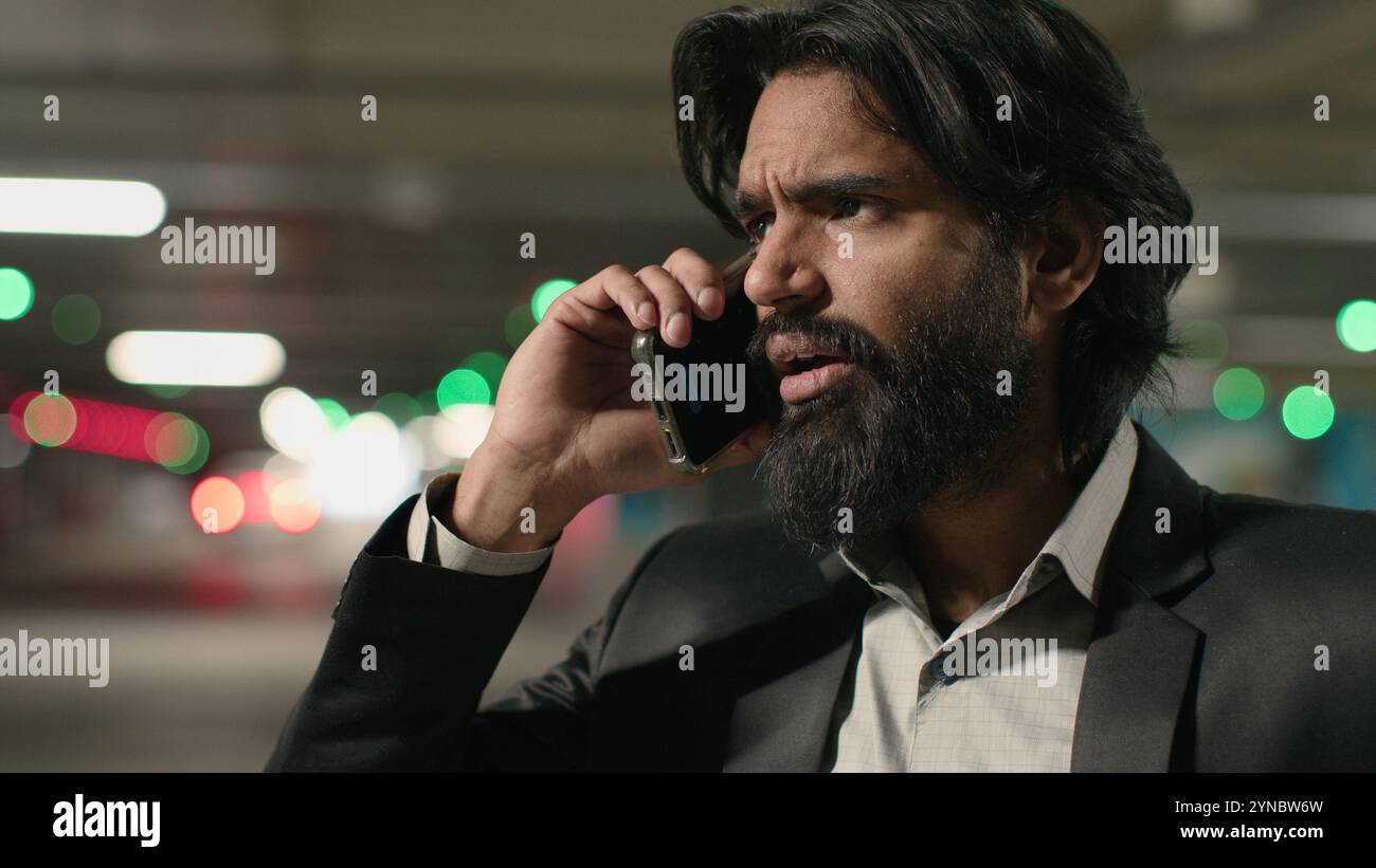 Stressed frustrated Indian man in underground parking lot suffering ...
