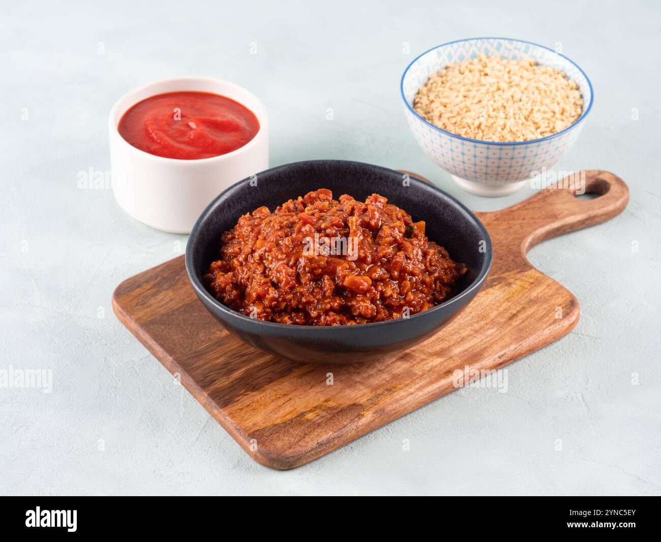 Vegan tomato bolognese ragu with soya protein granules in bowl Stock ...