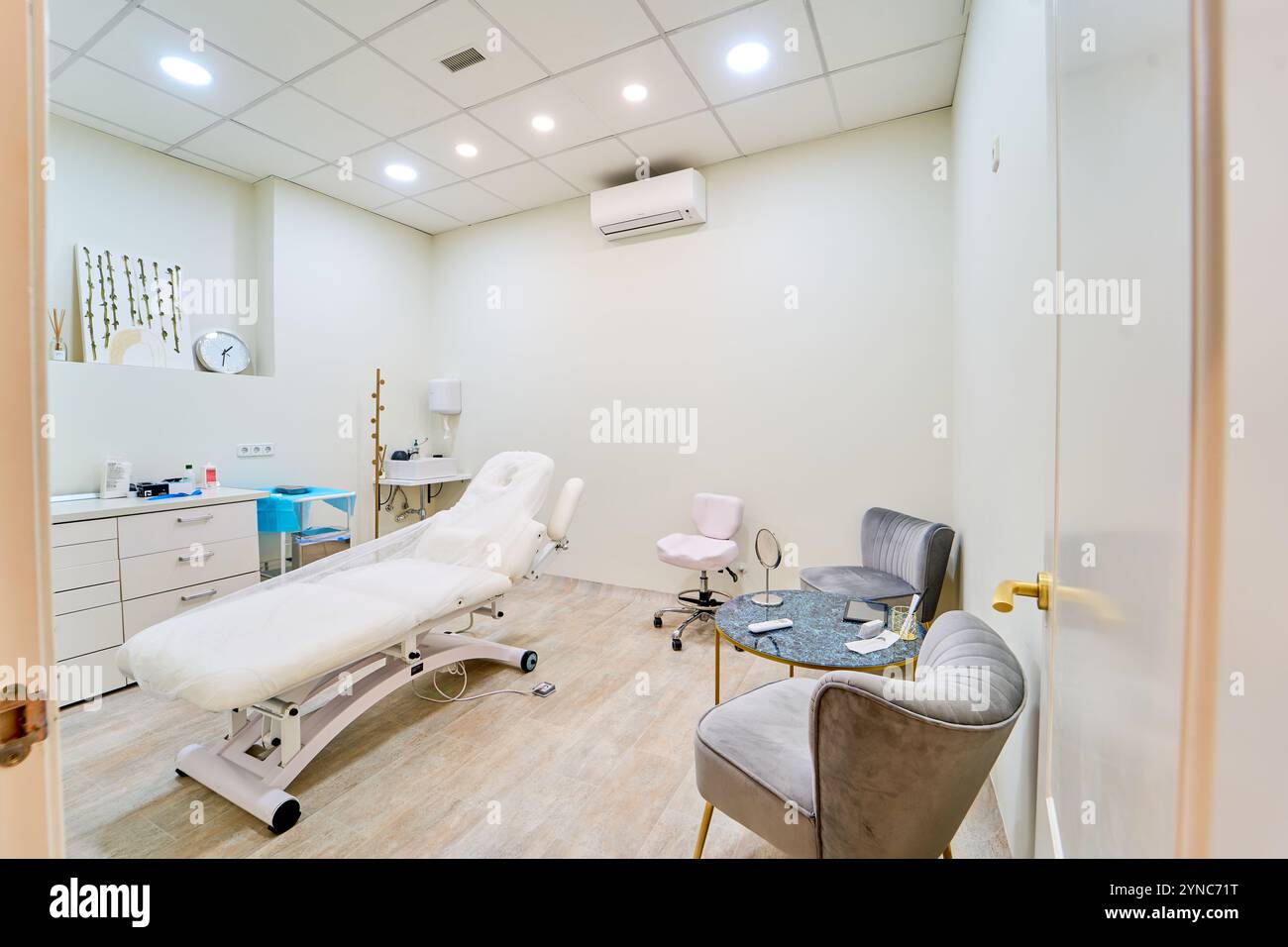 Modern and minimalistic medical treatment room with examination bed ...