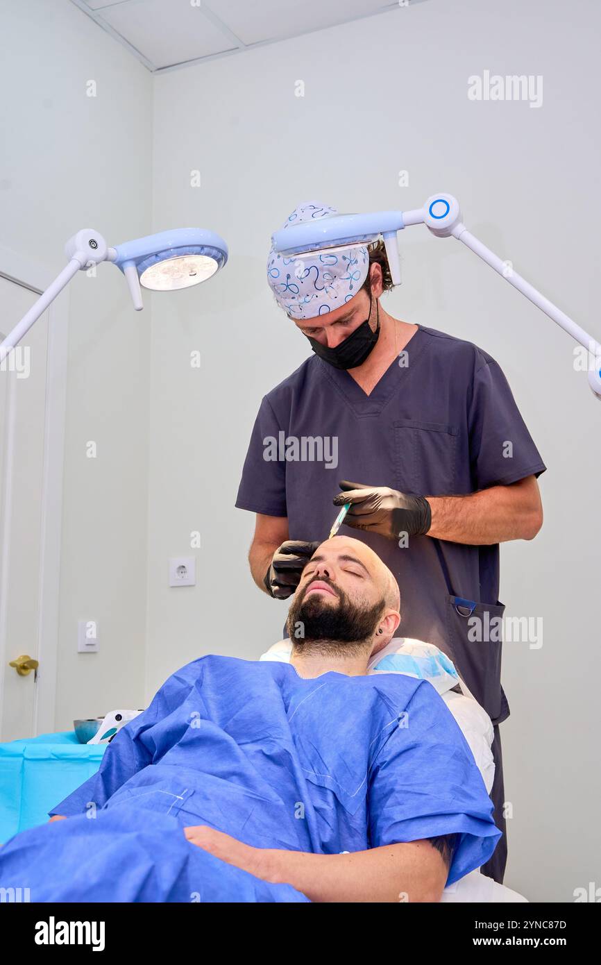 Doctor administering scalp injection during a hair transplant procedure ...