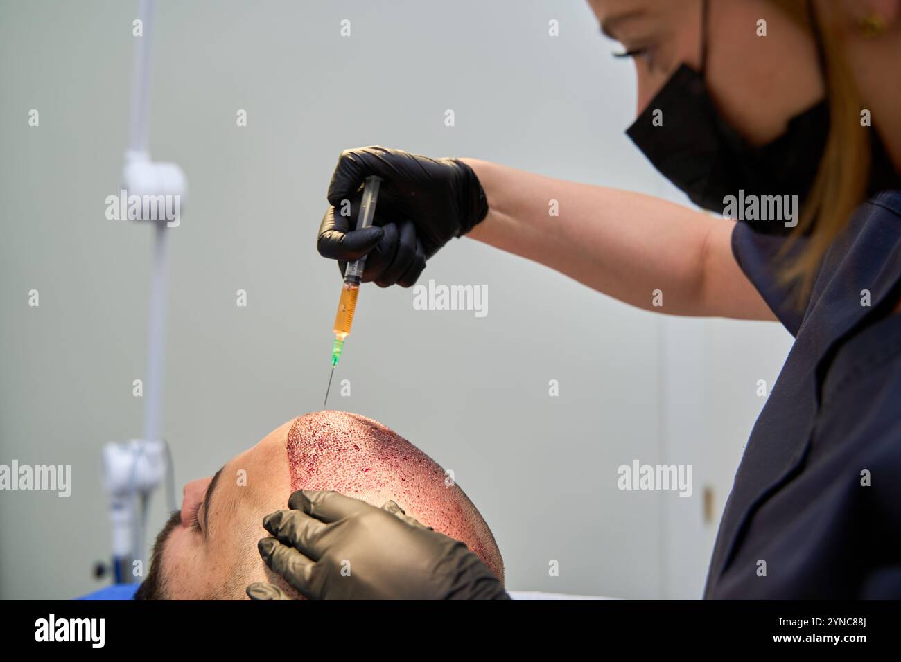 Doctor administering injection hi-res stock photography and images - Alamy