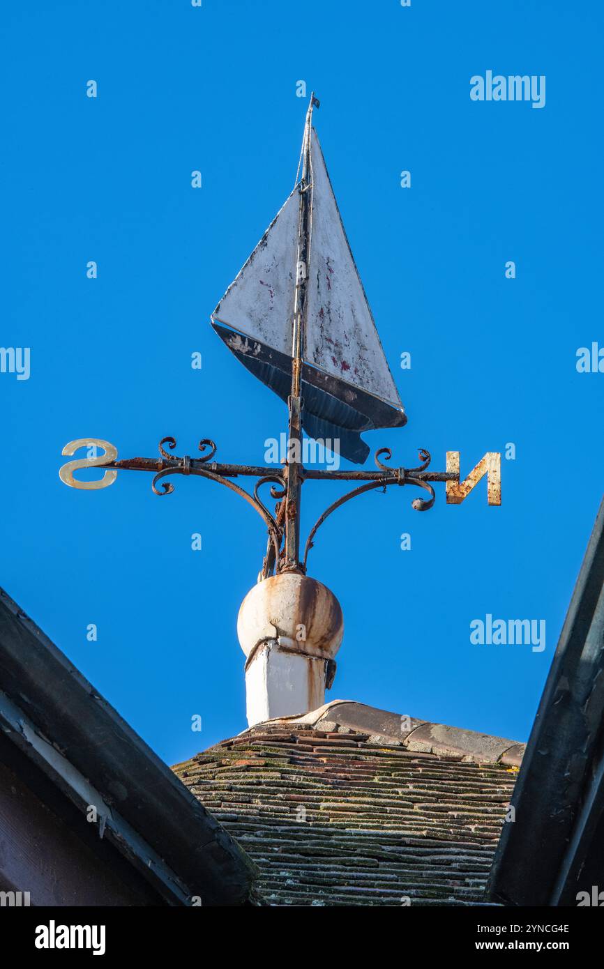 weathervane with yacht design on a rooftop chimney stack, wind ...