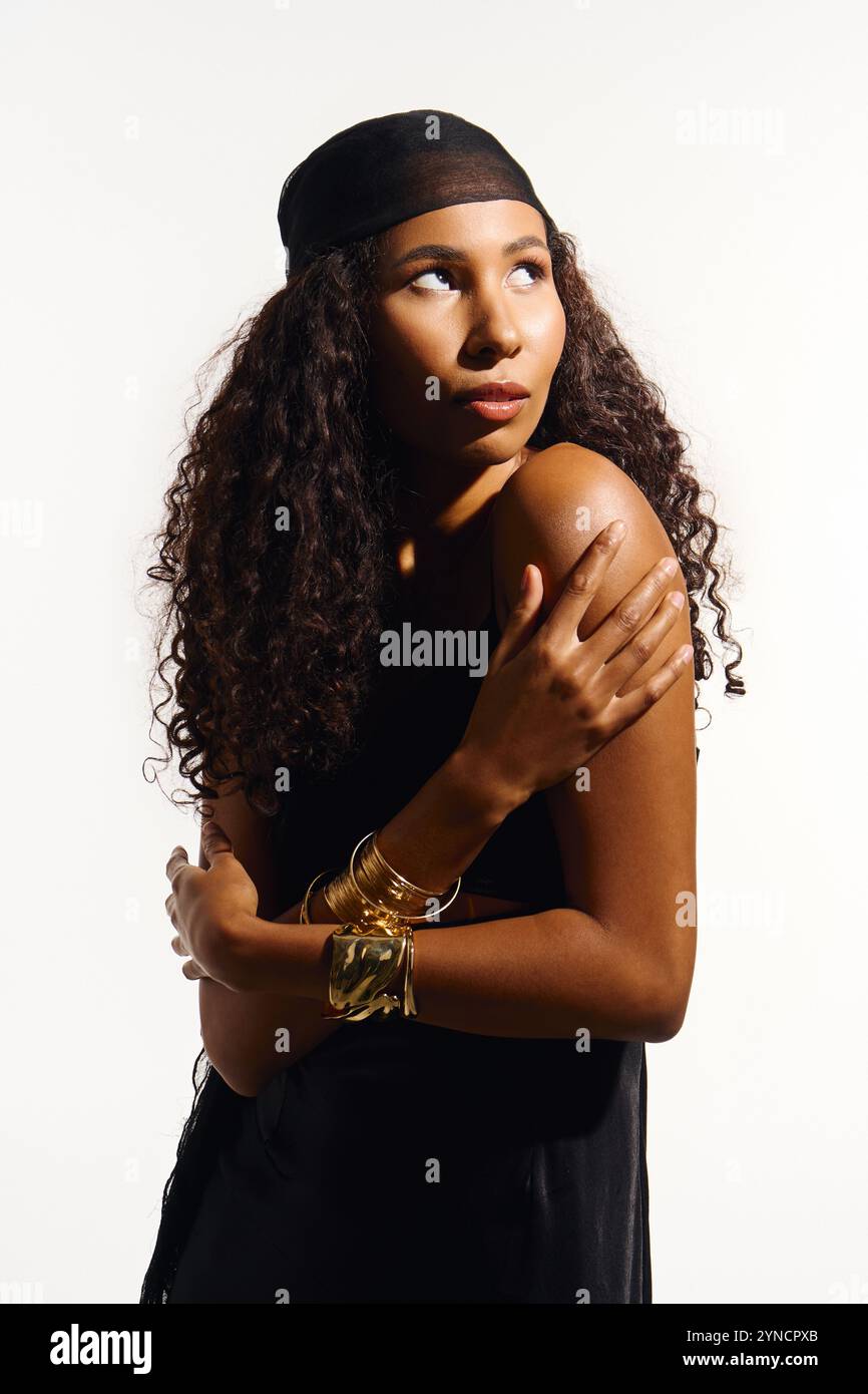 Beautiful woman with curly hair showcases elegance in a simple yet ...