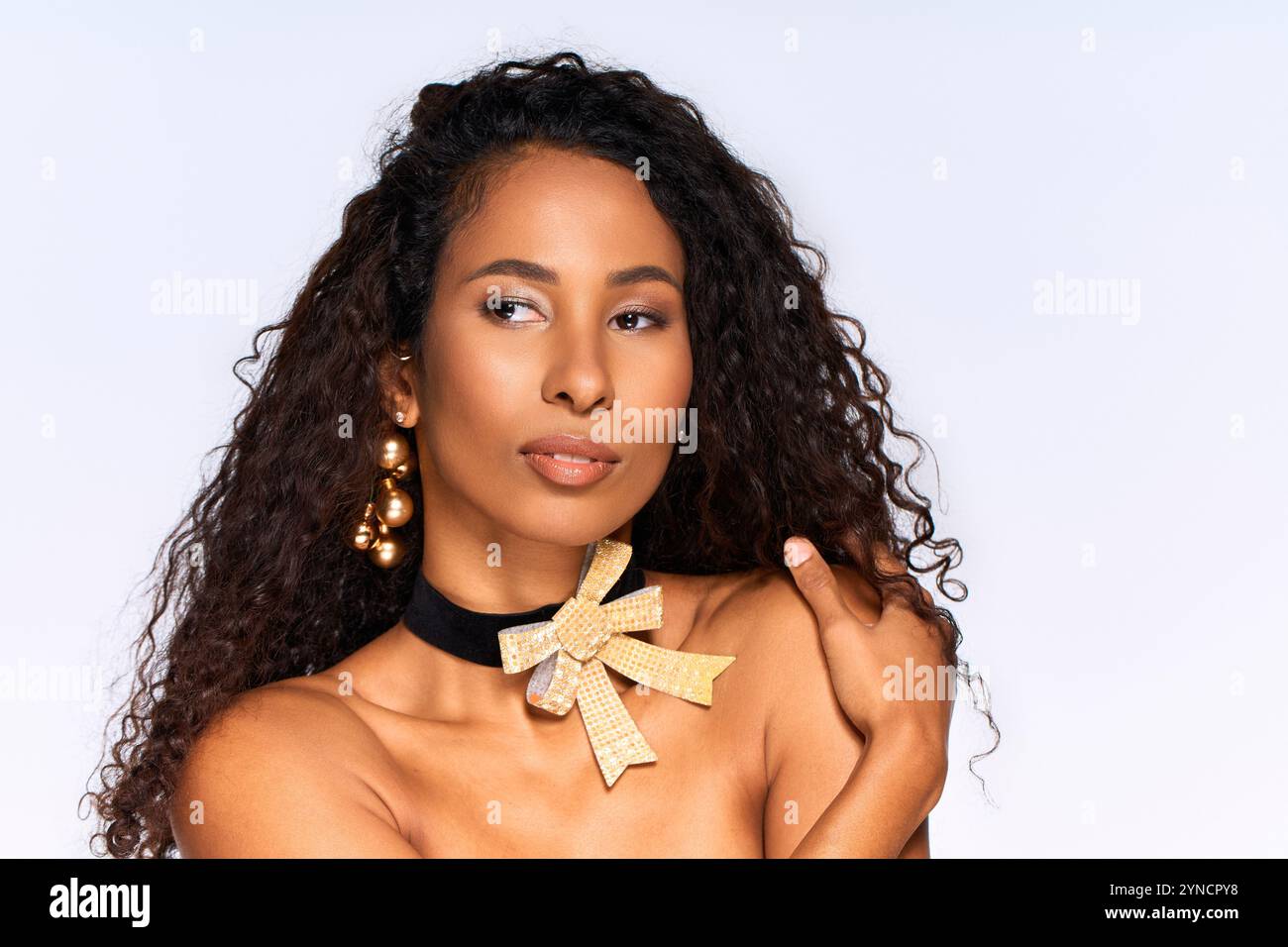 Stunning woman with curly hair showcases unique fashion and grace in a ...