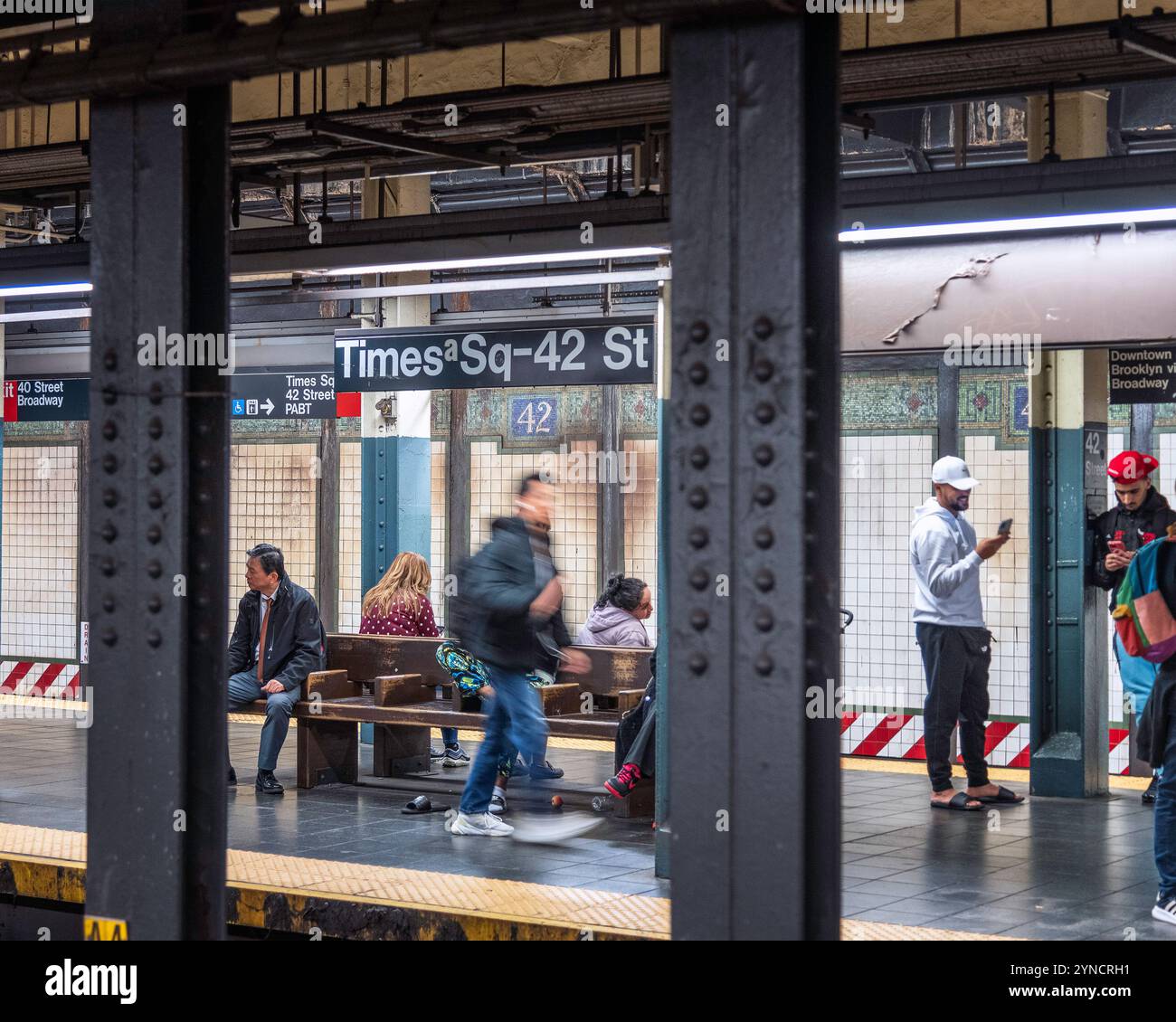 New York, New York, USA – October 30, 2024: Commuters wait on a subway ...