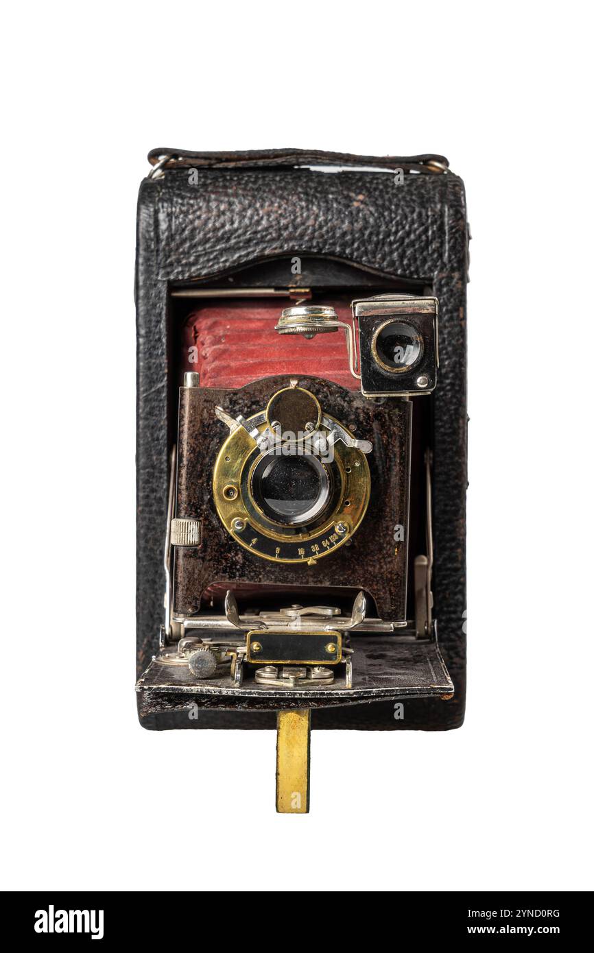 old 20th century photo camera with retractable lens on light background ...