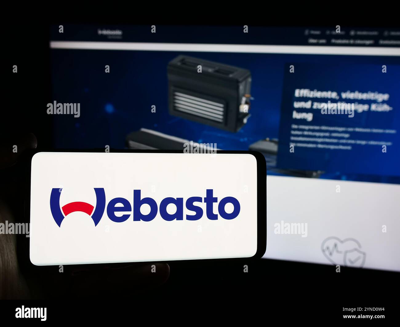 In this photo illustration, a person holds a mobile phone with the logo ...