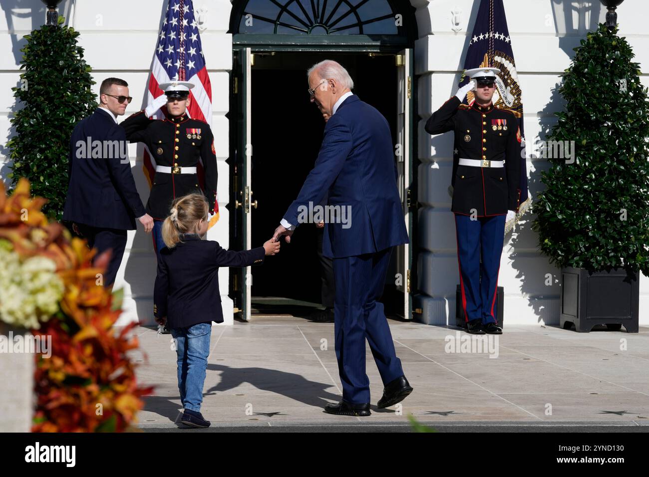 President Joe Biden grabs his grandchild, Beau Biden, after pardoning ...