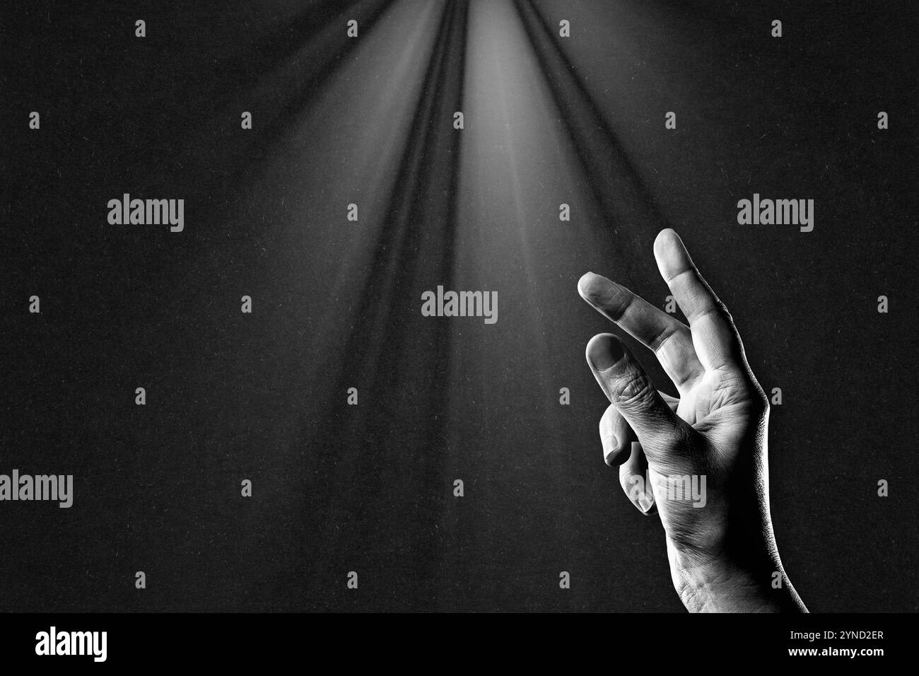 Hand Reaching Light in Black and White on Textured Paper Background ...