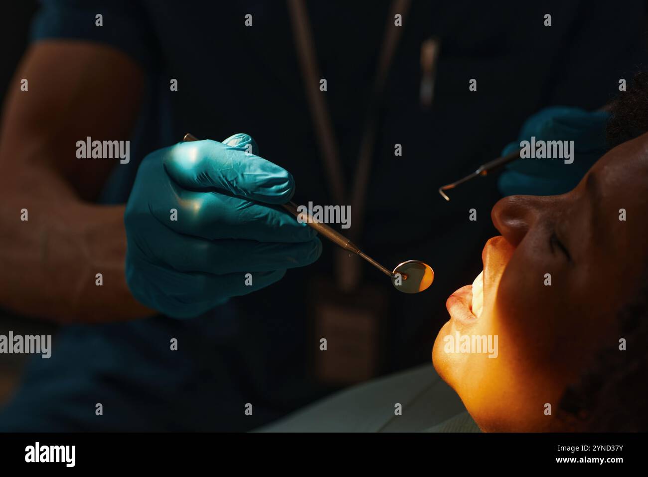 Performing Dental Procedure in Medical Clinic Stock Photo - Alamy