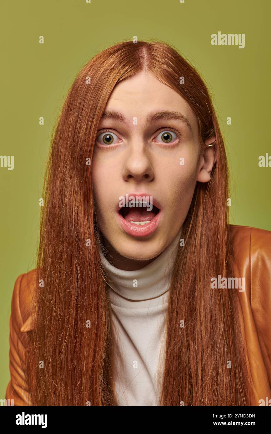 Young man expresses surprise with wide eyes and open mouth, showcasing ...