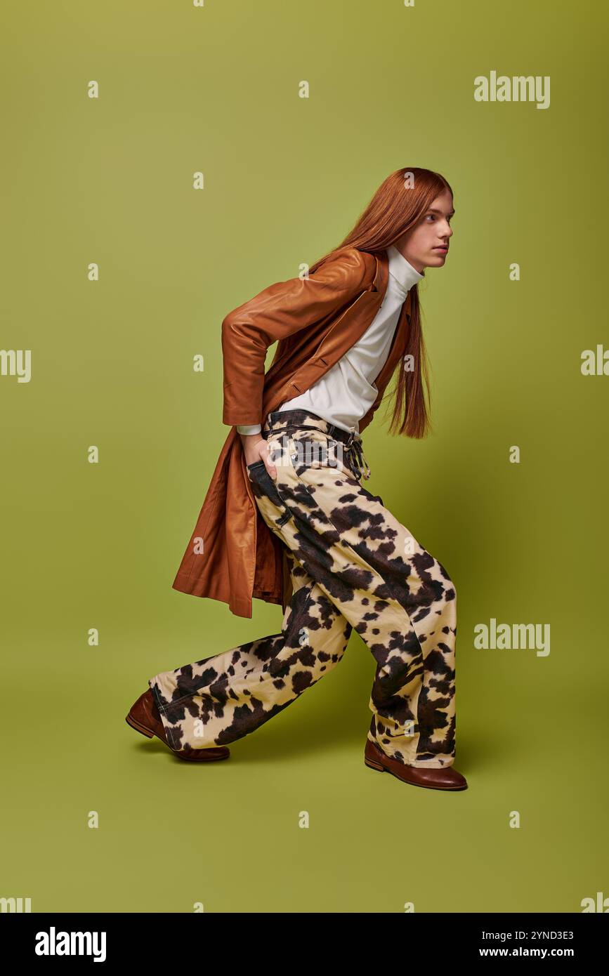 A young man with long red hair exhibits strong emotions while wearing a ...