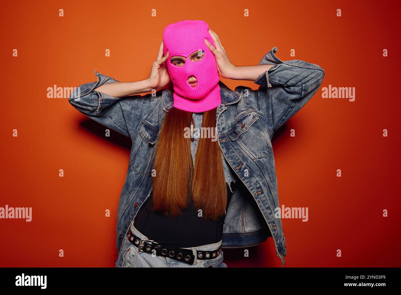 Young man showcases strong emotions while wearing a bright ski mask ...