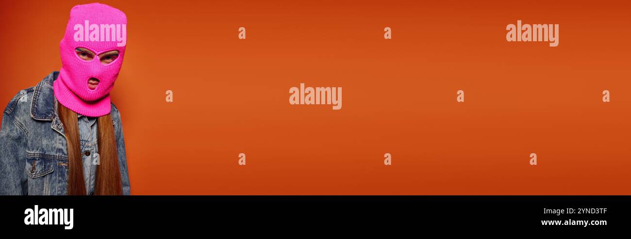 A young man with long red hair displays strong emotions wearing a bold ...