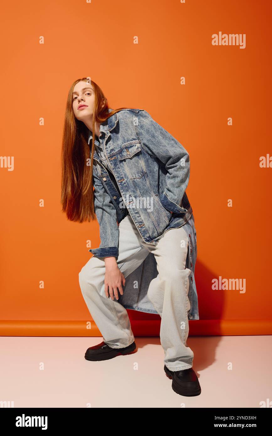 A young man with long red hair strikes a unique pose, expressing deep emotions Stock Photo - Alamy