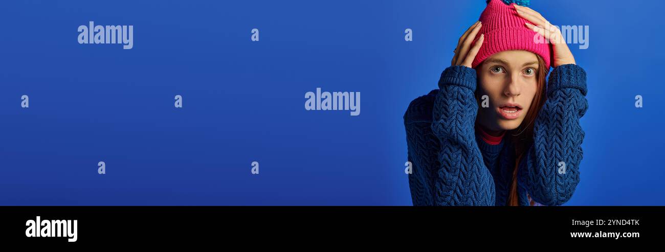 Emotional young man with long red hair reacting dramatically in a ...