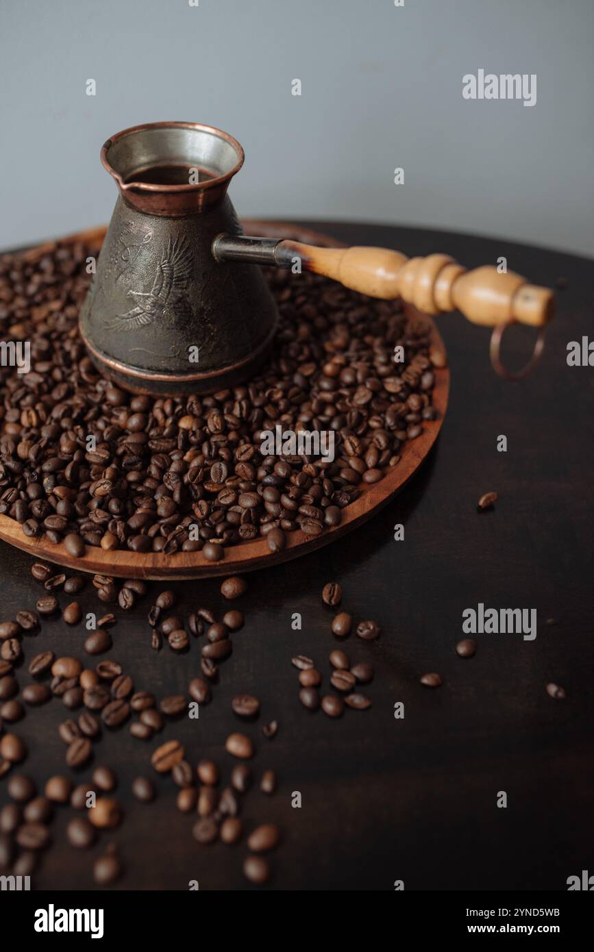 a traditional Turkish coffee pot (turka) alongside scattered coffee ...