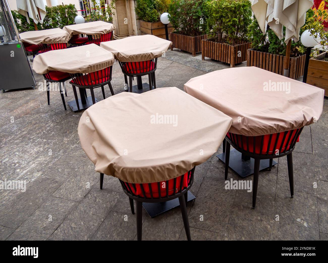 Empty covered tables at a street cafe Stock Photo - Alamy