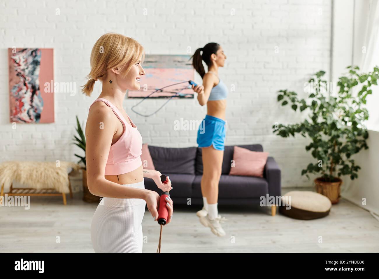 Two young women happily workout together, showcasing their loving ...