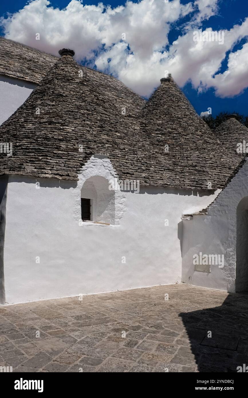 Conical roofs on a building made up of connected trulli in Alberobello ...