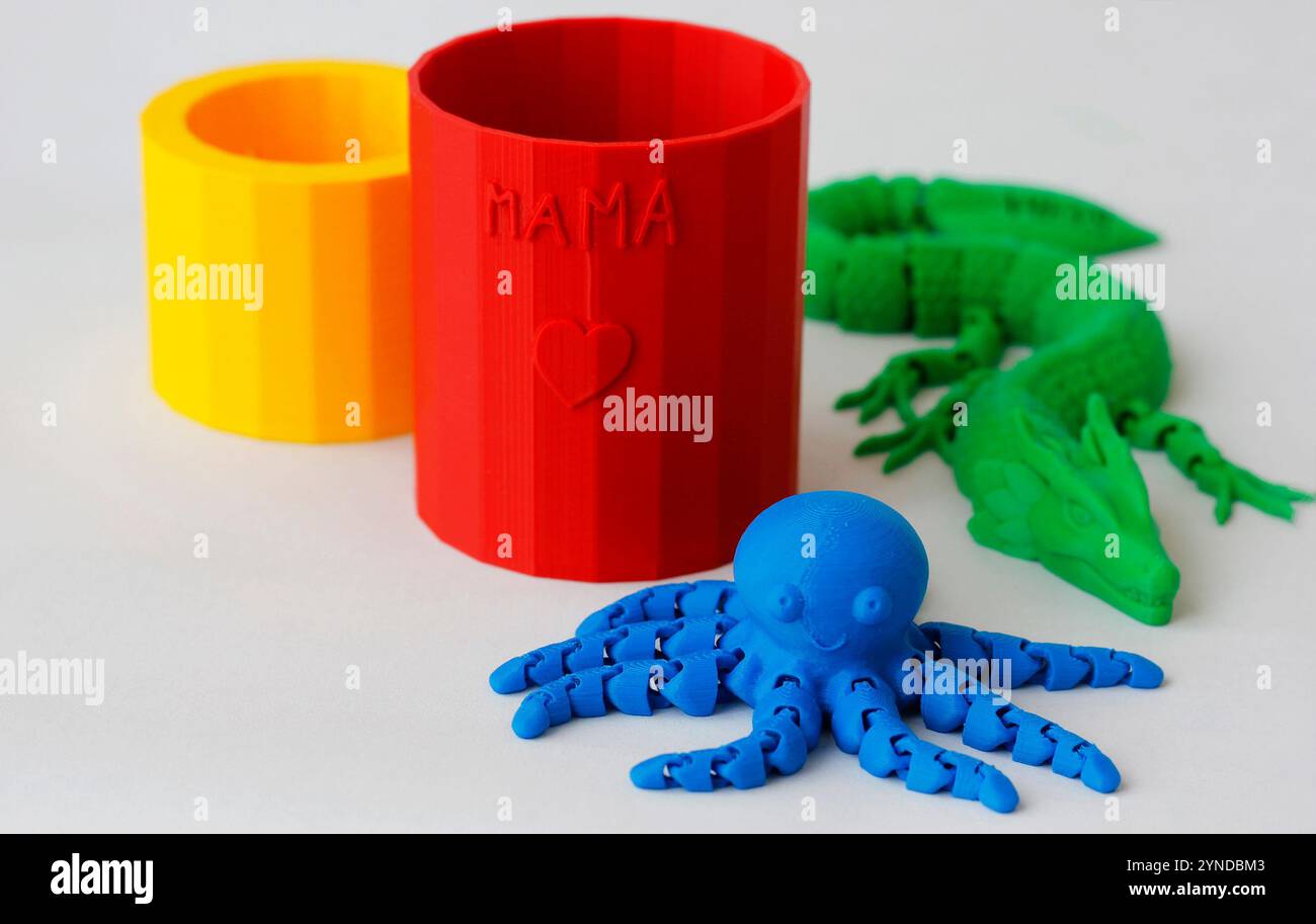 Collection of four bright colorful plastic products created by a child ...