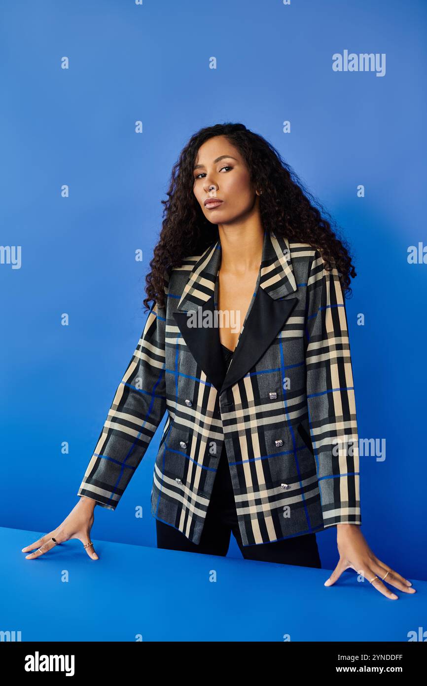 A confident woman stands with poise, showcasing her stylish outfit in a ...